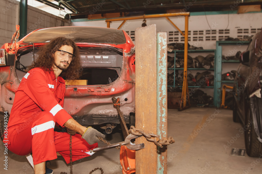 Car mechanic workers garage where accident happened using heavy tools ...