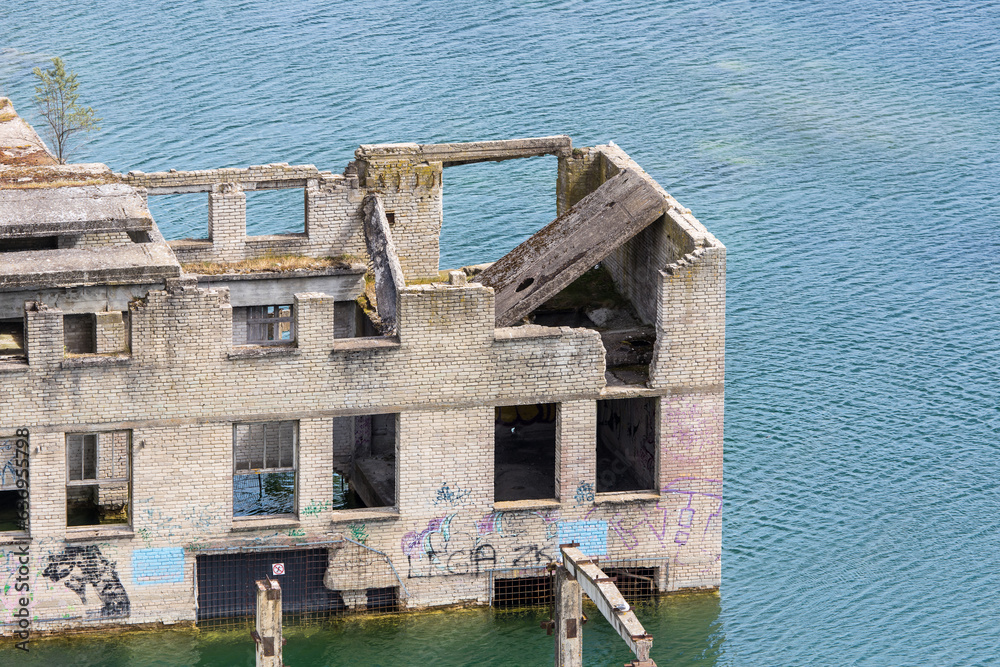 Flooded abandoned ruin building of former jail in Rummu, Estonia as ...