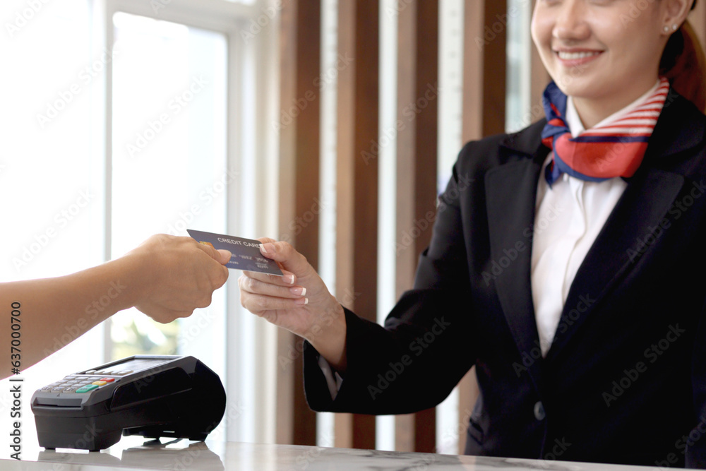 Female receptionist hand reaching out for receiving credit card form ...