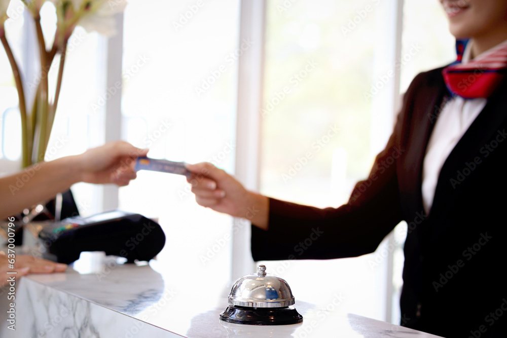 Silver bell on hotel reception service desk with blurred background of ...