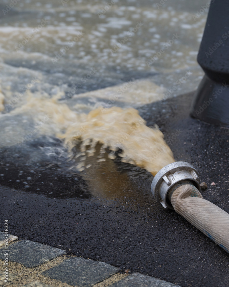 Water pump at floods in the city streets after heavy rain. Severe ...