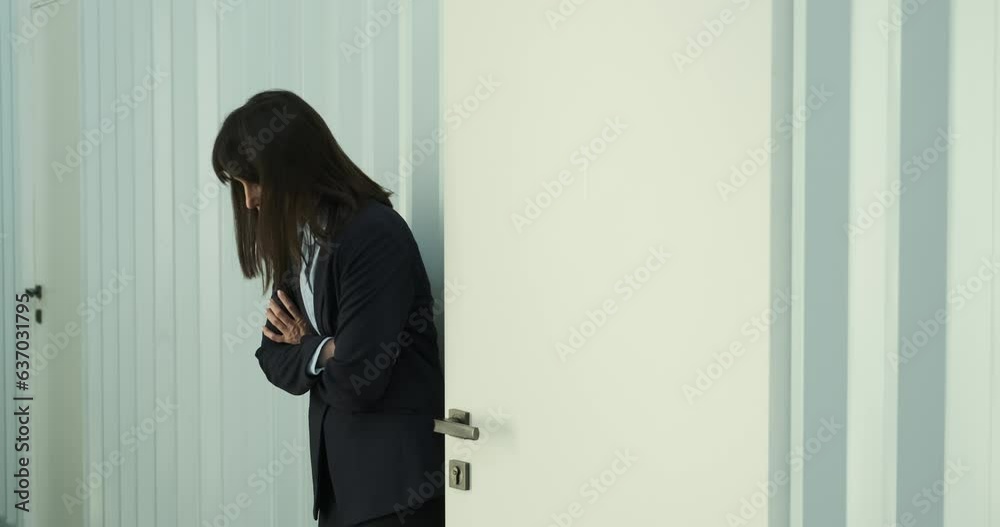 Dejected office worker as she steps out of the office with a heavy ...
