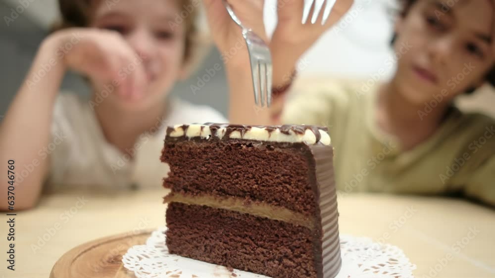 Two brothers 5 and 7 years old share chocolate cake celebration enjoy ...