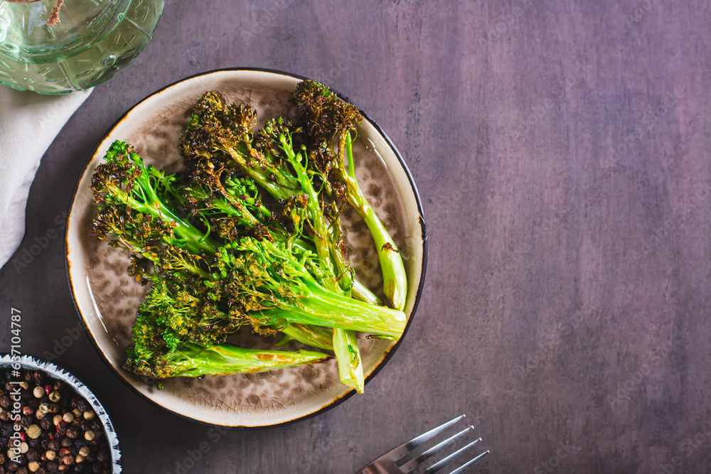 Fried green broccoli sprouts on a plate on the table top view Stock ...