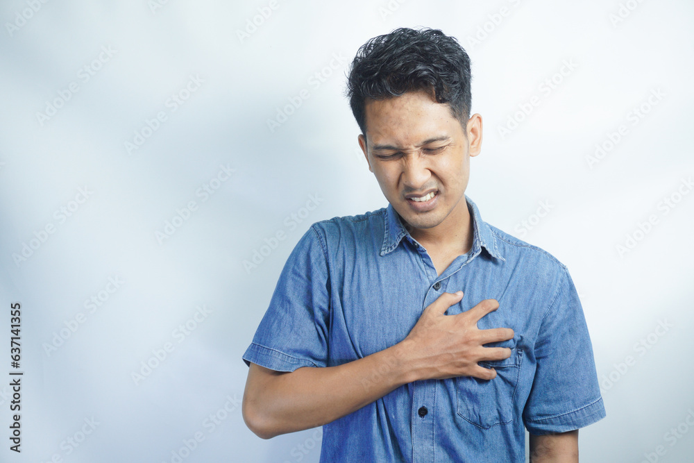 unhappy man suffering from heart ache. Hands holding chest with symptom ...