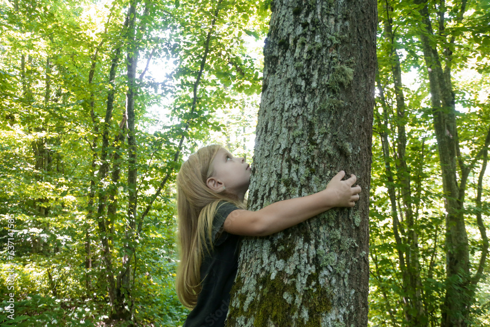Cute little girl hugging tree. Hugging and touching trees provide rich ...