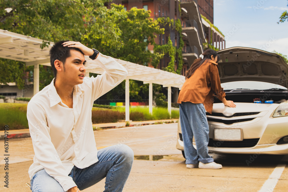 Handsome man sitting headache about the car parked side of the road ...