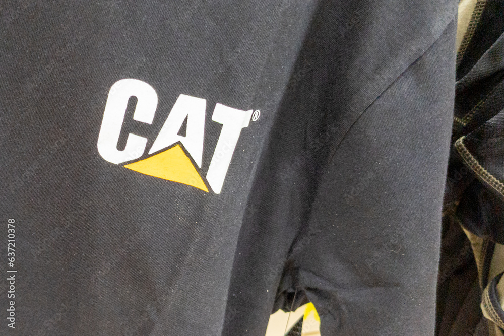 cat sign logo Caterpillar and brand text on shirt in fashion shop ...