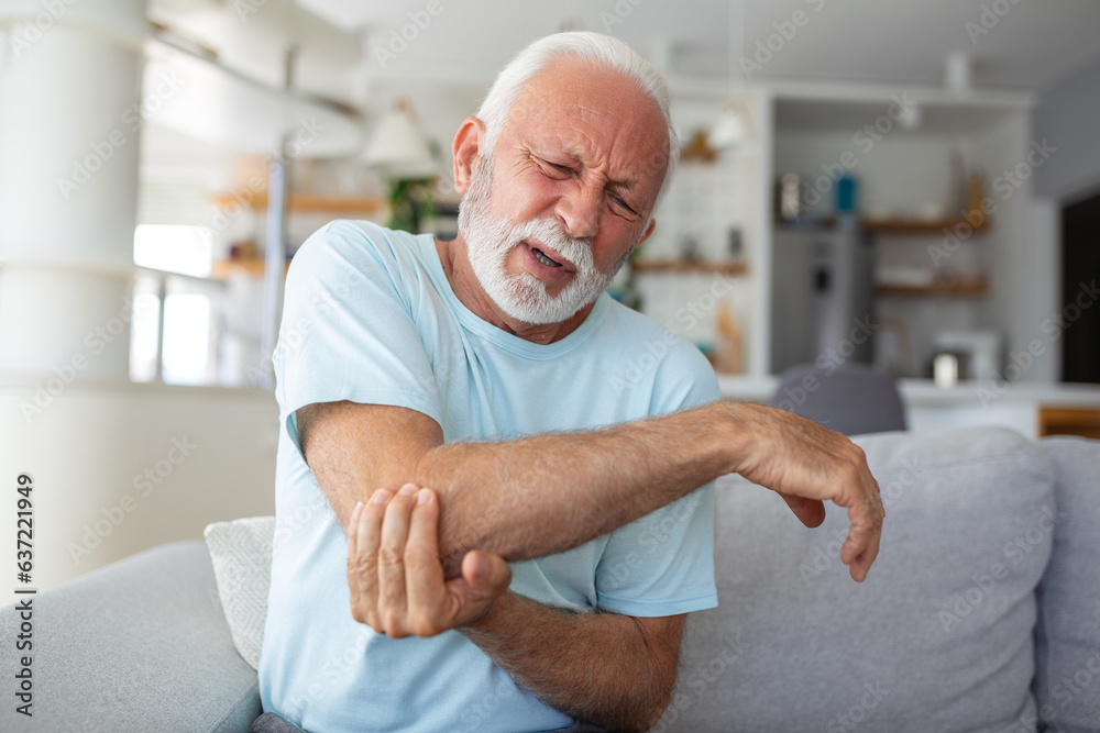 Senior man with arm pain.Old male massaging painful hand indoors. Old ...