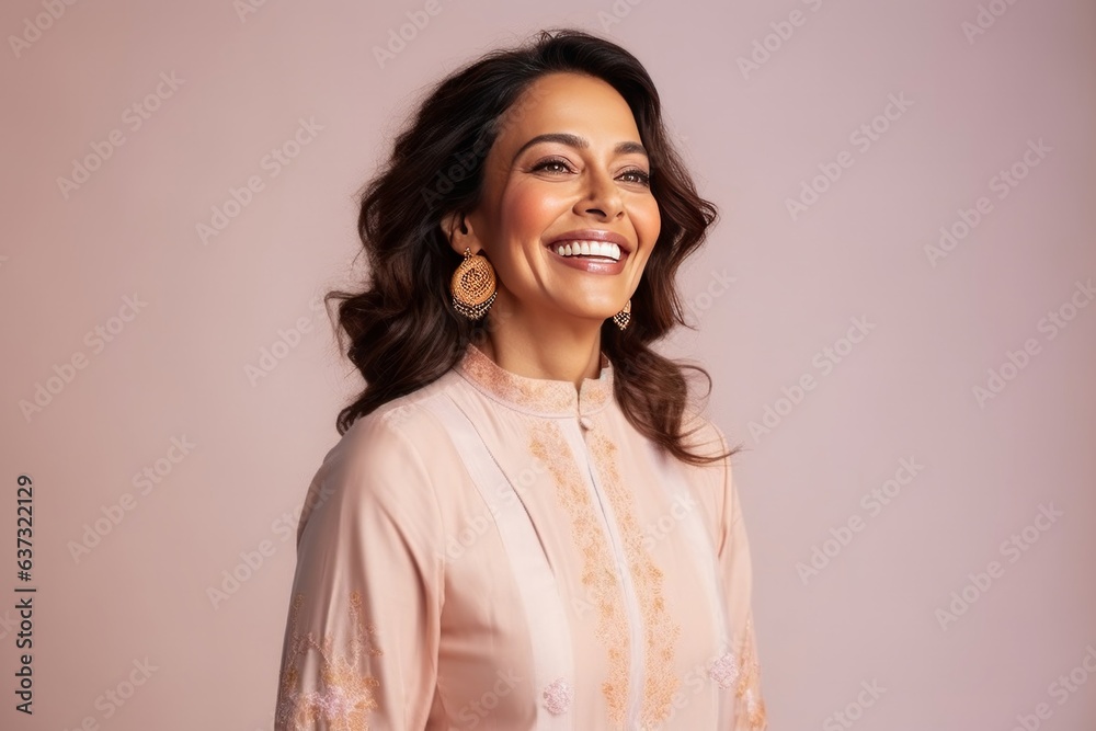 Medium shot portrait of an Indian woman in her 40s wearing sherwani in ...