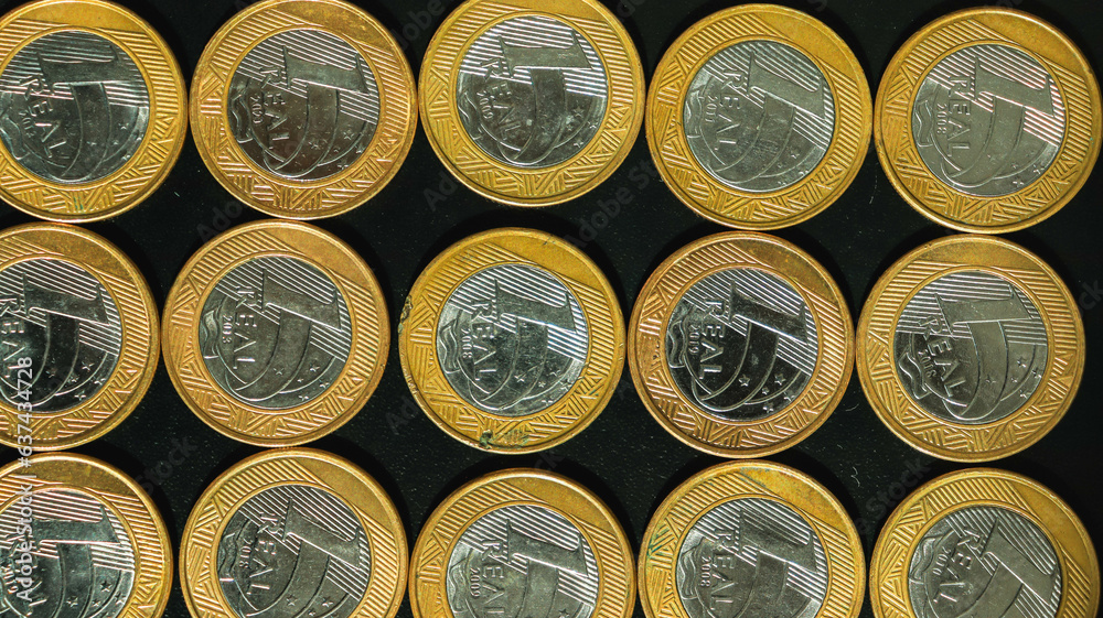 moedas de um real em um fundo preto Stock Photo | Adobe Stock