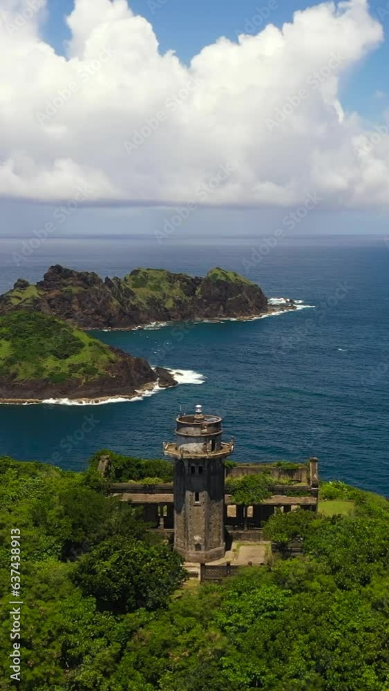 Lighthouse and tropical islands on the background of the blue ocean ...