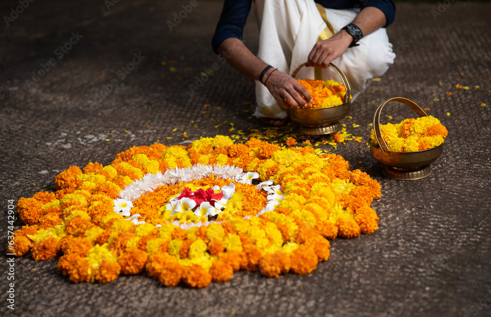 Beautiful flower decoration for Onam festival, Young Indian man making ...