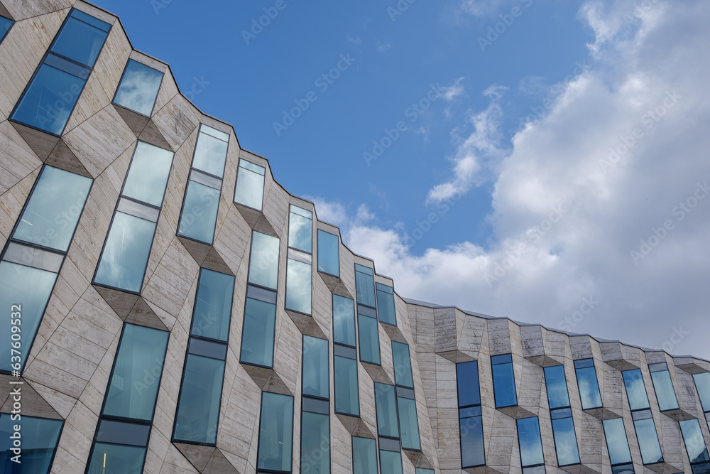 Vertical random pattern of rectangular glass windows and cream granite ...