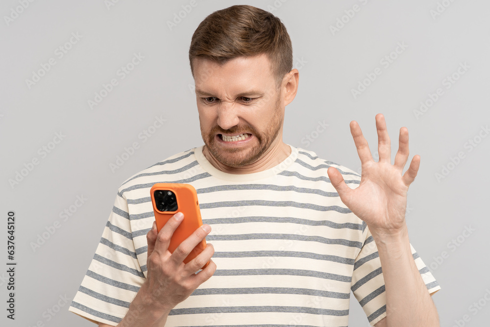 Unkind man angry looks screen smartphone, aggressive video call ...