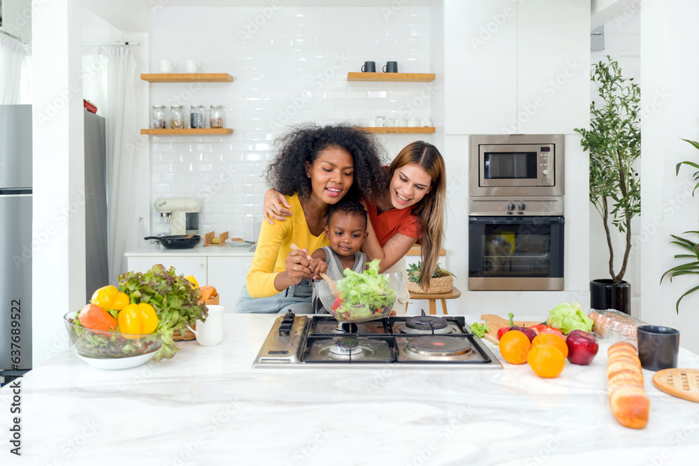 Two women a child, cooking together in a well-lit, homey kitchen ...