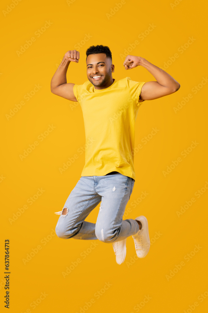 Full length portrait of overjoyed athletic indian guy jumping high and ...