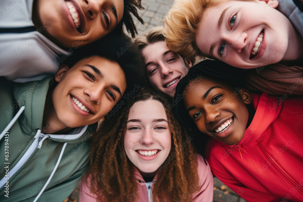 Teenagers from diverse backgrounds coming together in a huddle ...