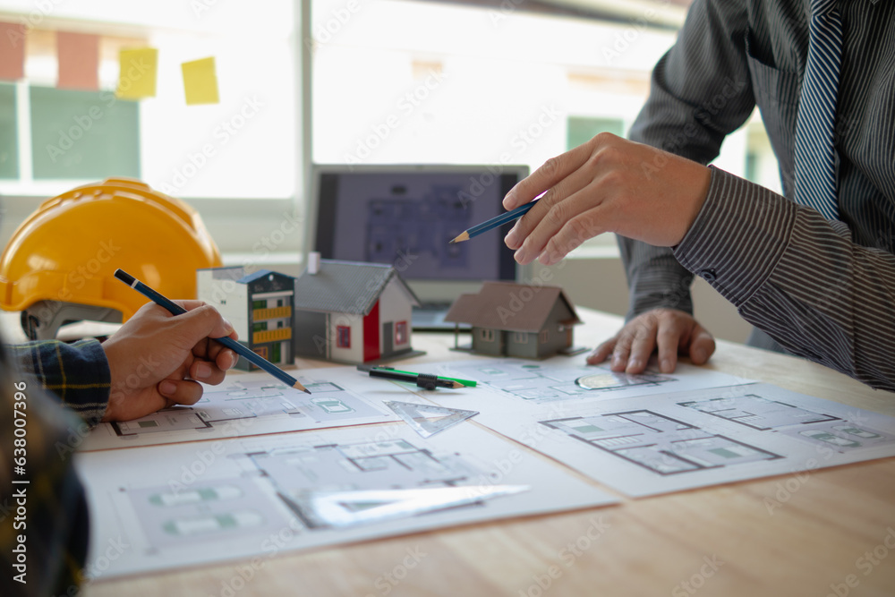 Construction engineers discuss and exchange ideas with architects to ...