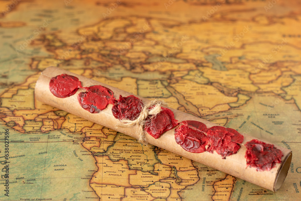 Ancient scroll with seven seals on an old world map. Christian prophecy ...