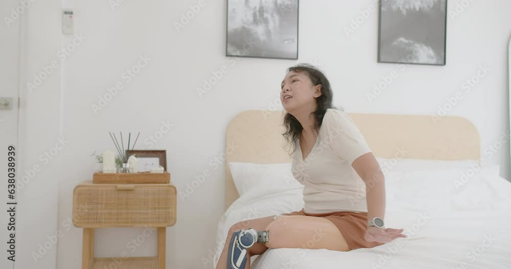Happy Disabled Asian woman amputee remove prosthetic leg take a rest ...