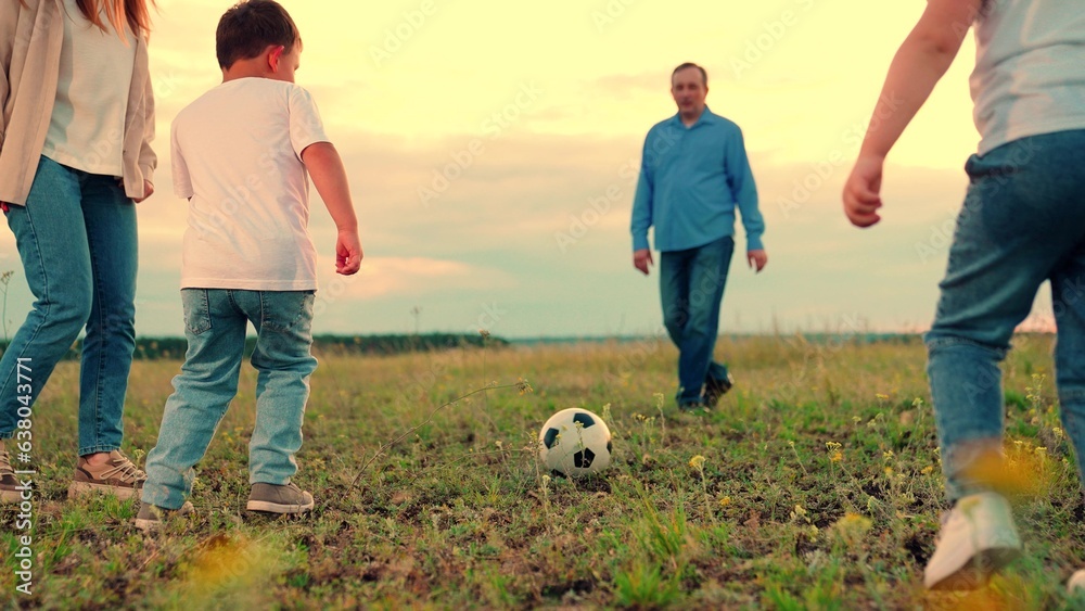 Happy family playing football. Child kicks ball. Family have fun ...