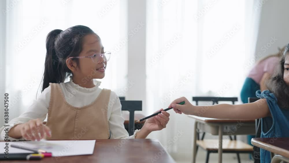 Asian little girls classmate using pencil writing on notebook for ...