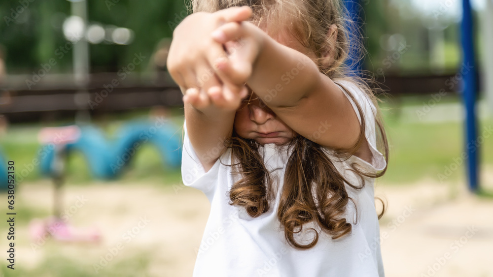 Cute caucasian baby, little girl crying on the playground in the park ...