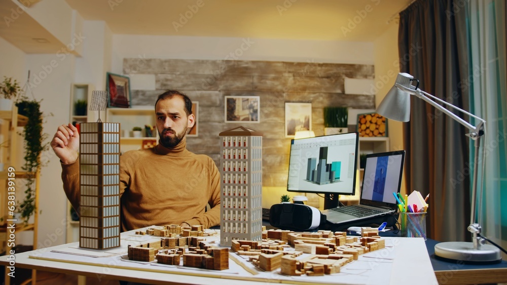 Construction developer working in office on creation of new residential ...