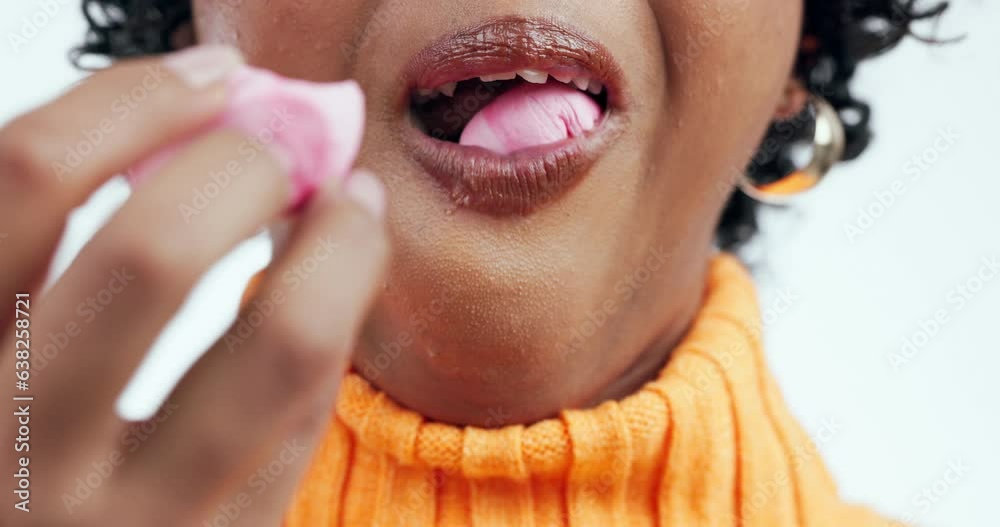 Mouth, marshmallow and greed with a woman eating candy in studio on a ...