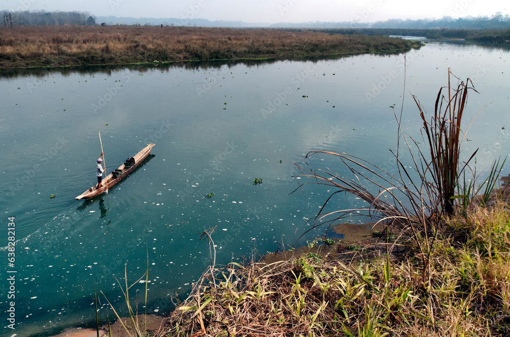 Nepal, Asia, man in dugout canoe on Narayani-Rapti river, Chitwan ...