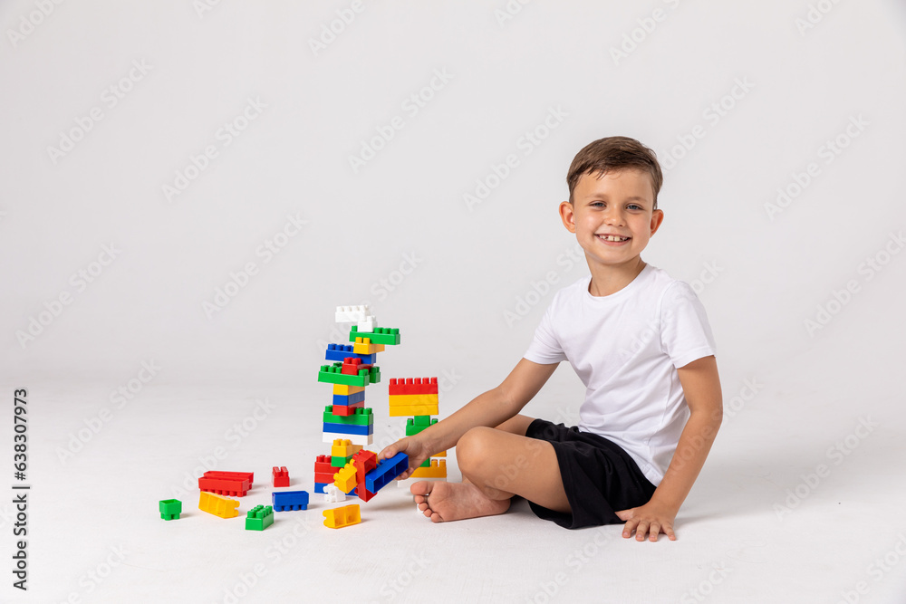 Toddler playing with educational blocks. A happy child collects a tower ...