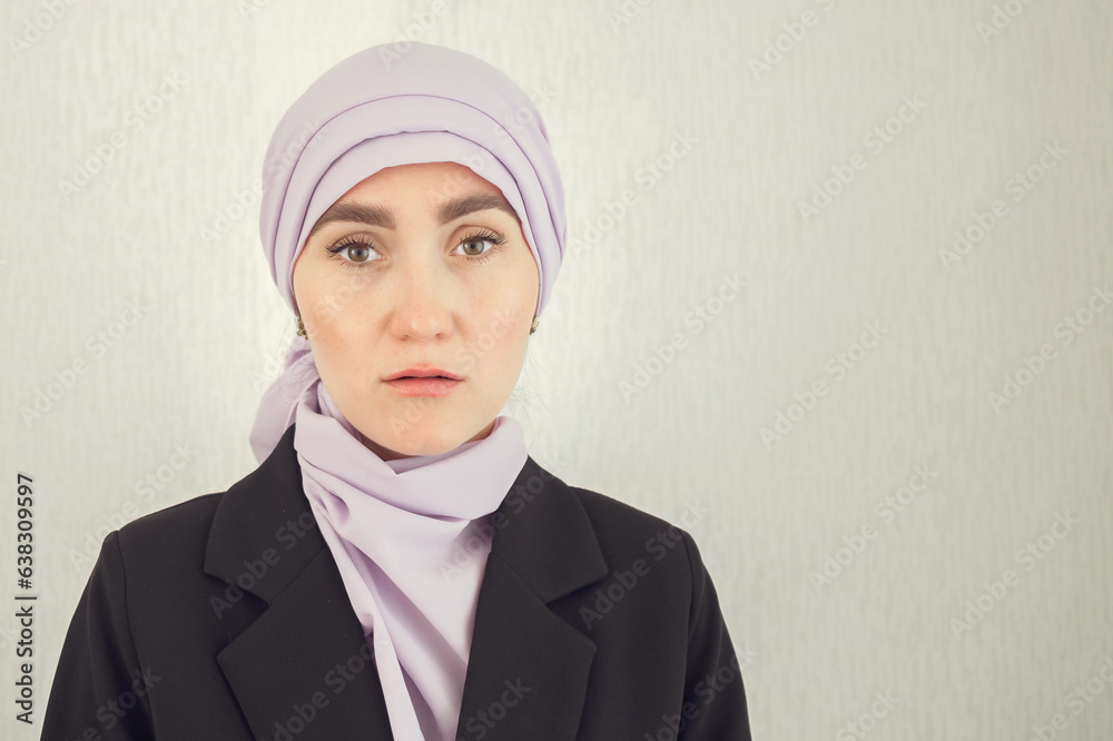 Muslim woman in pinkish hijab looks with depressed and upset expression ...