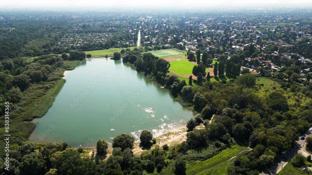 Explore a sun-drenched summer landscape by drone: a sprawling field, a ...
