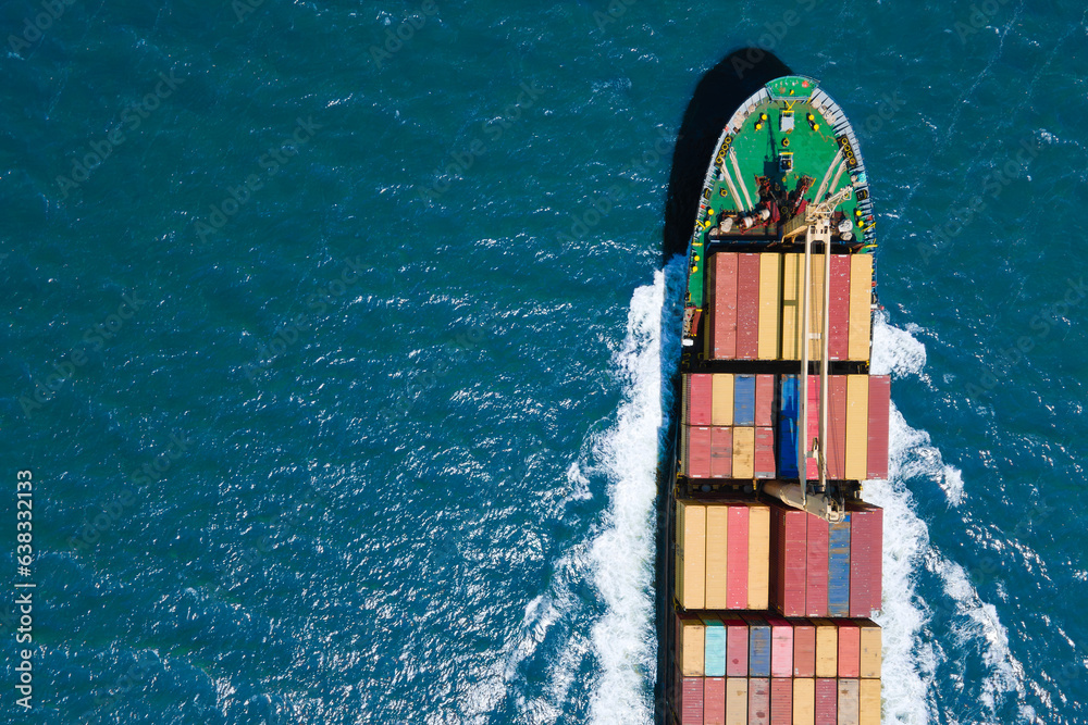 Aerial footage of large container ship cruising in open sea, top down ...
