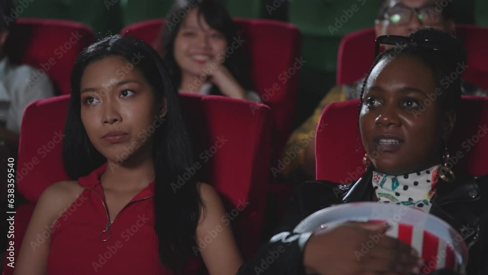 Displeased women the man sitting in the back seat while watching movie ...