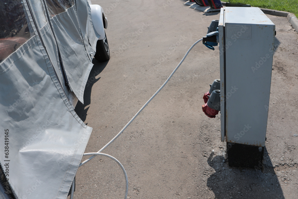 Process of charging an electric car in megalopolis. Electric car is ...