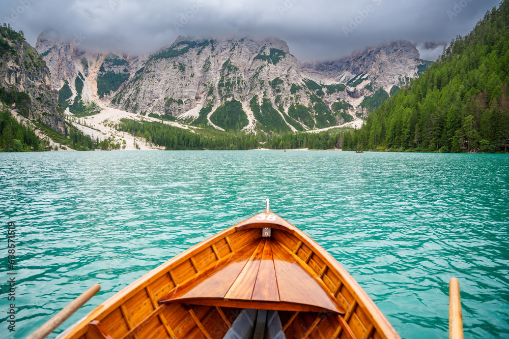 Traditional wooden rowing boat on scenic Lago di Braies in the ...