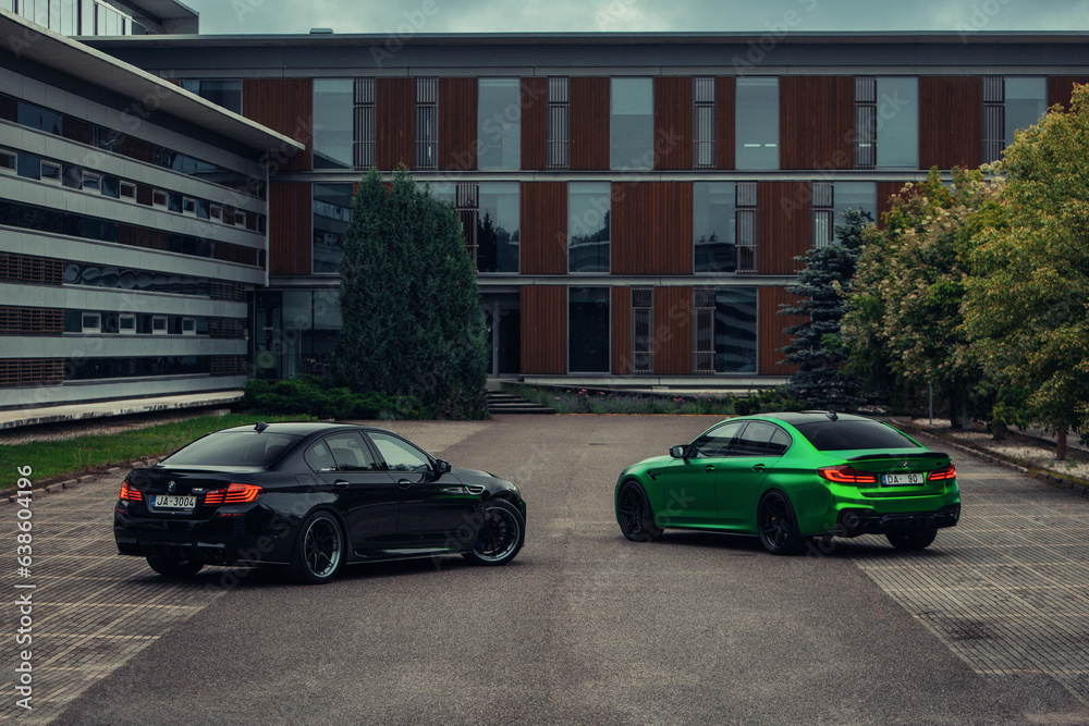 BMW M5 F90 and BMW F10 M5 Competition at the parking of business center ...