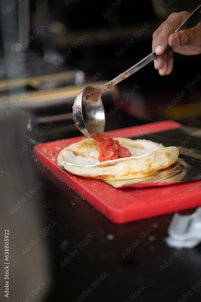 Malawach, a traditional Yemeni Jewish dish, being prepared at a food ...