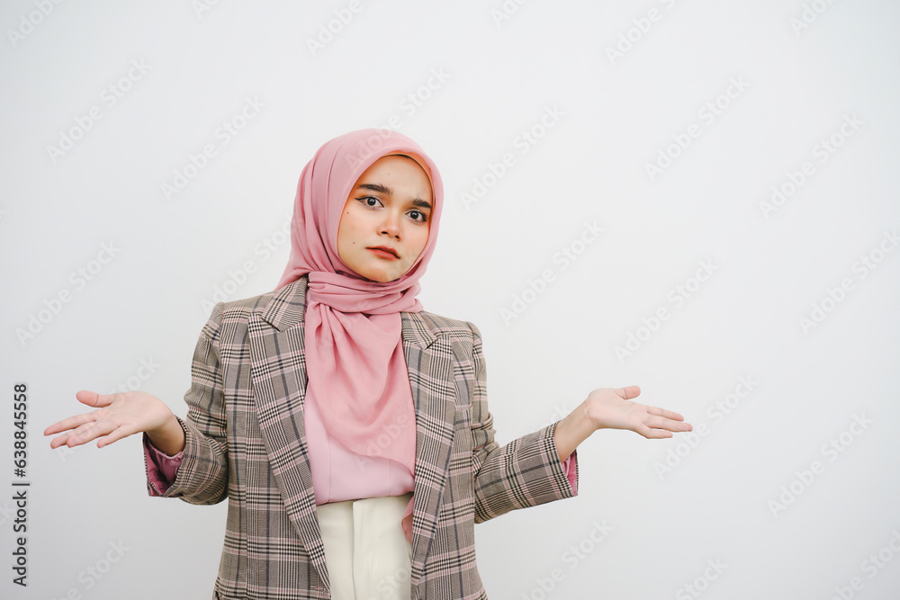 Beautiful young muslim businesswoman pink hijab shrugging shoulders ...