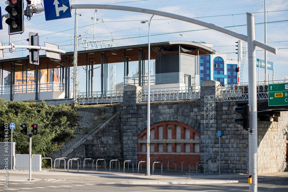 Crossroad in European city. Railway bridge with a station over the ...
