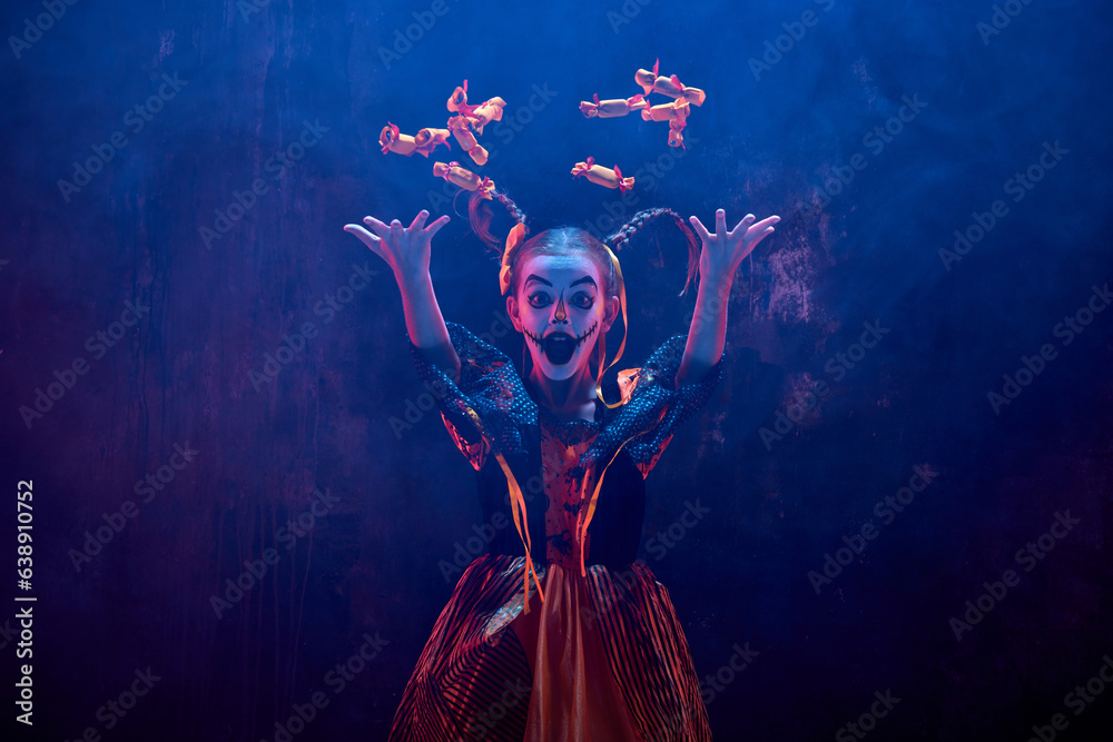 Little girl, child in costume and makeup for halloween throwing sweets ...