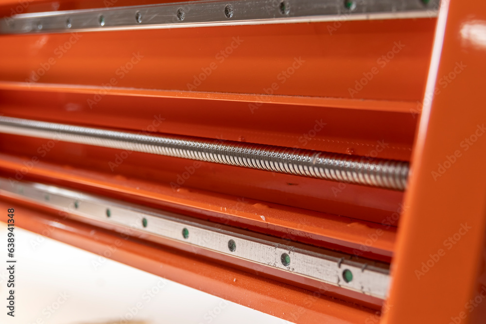 Orange CNC machine, ball screw and pallid metal guides Stock Photo ...