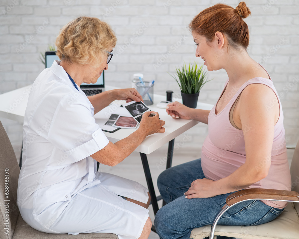 Obstetrician gynecologist explaining the screening picture to a ...