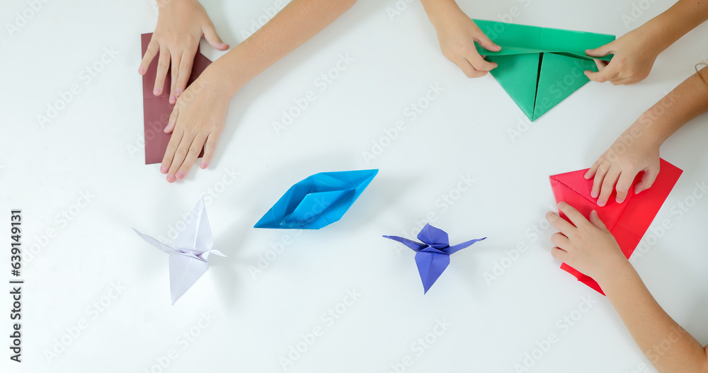 School children on vacation sit on the couch and fold origami Stock ...