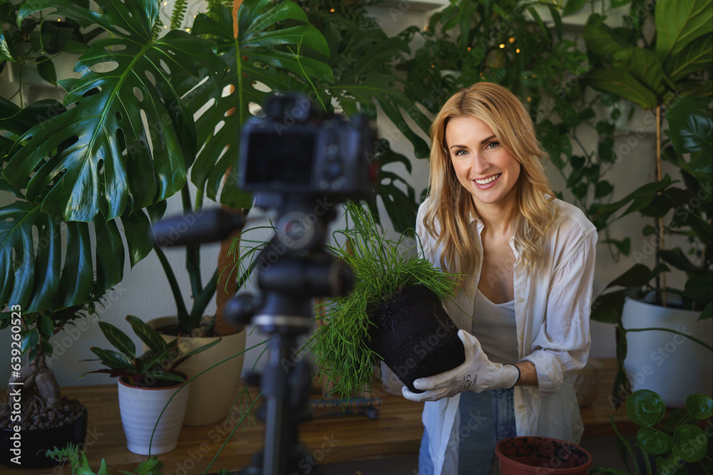 Plant-loving blogger in a white shirt and jeans, smiling in the natural ...