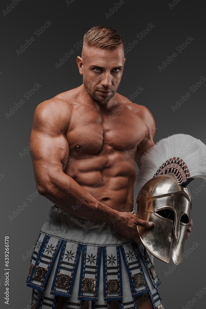 A muscular and attractive male model dressed in ancient drapes and ...