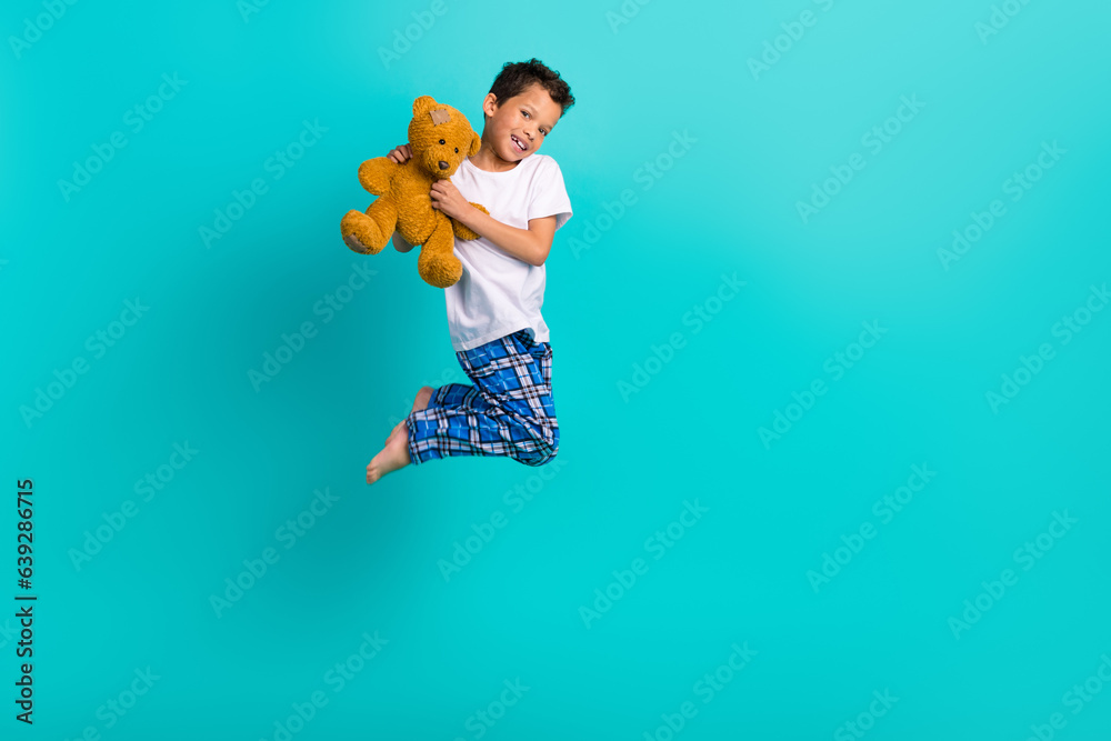 Full size photo of active excited small kid hold fluffy soft teddy bear ...