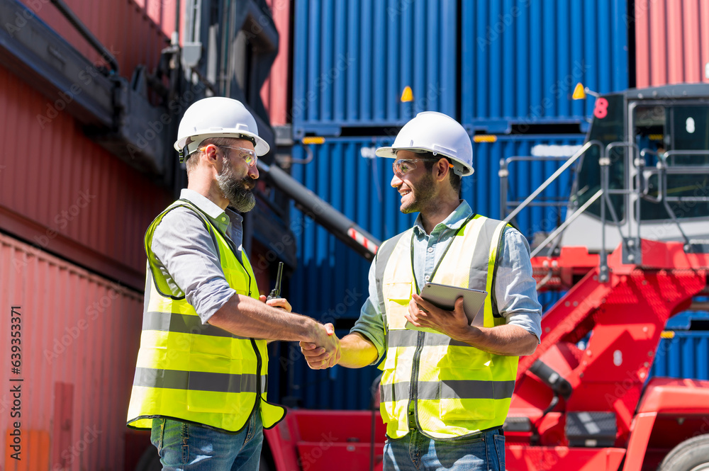 Logistics engineer and inspector holding hands with teamwork working ...